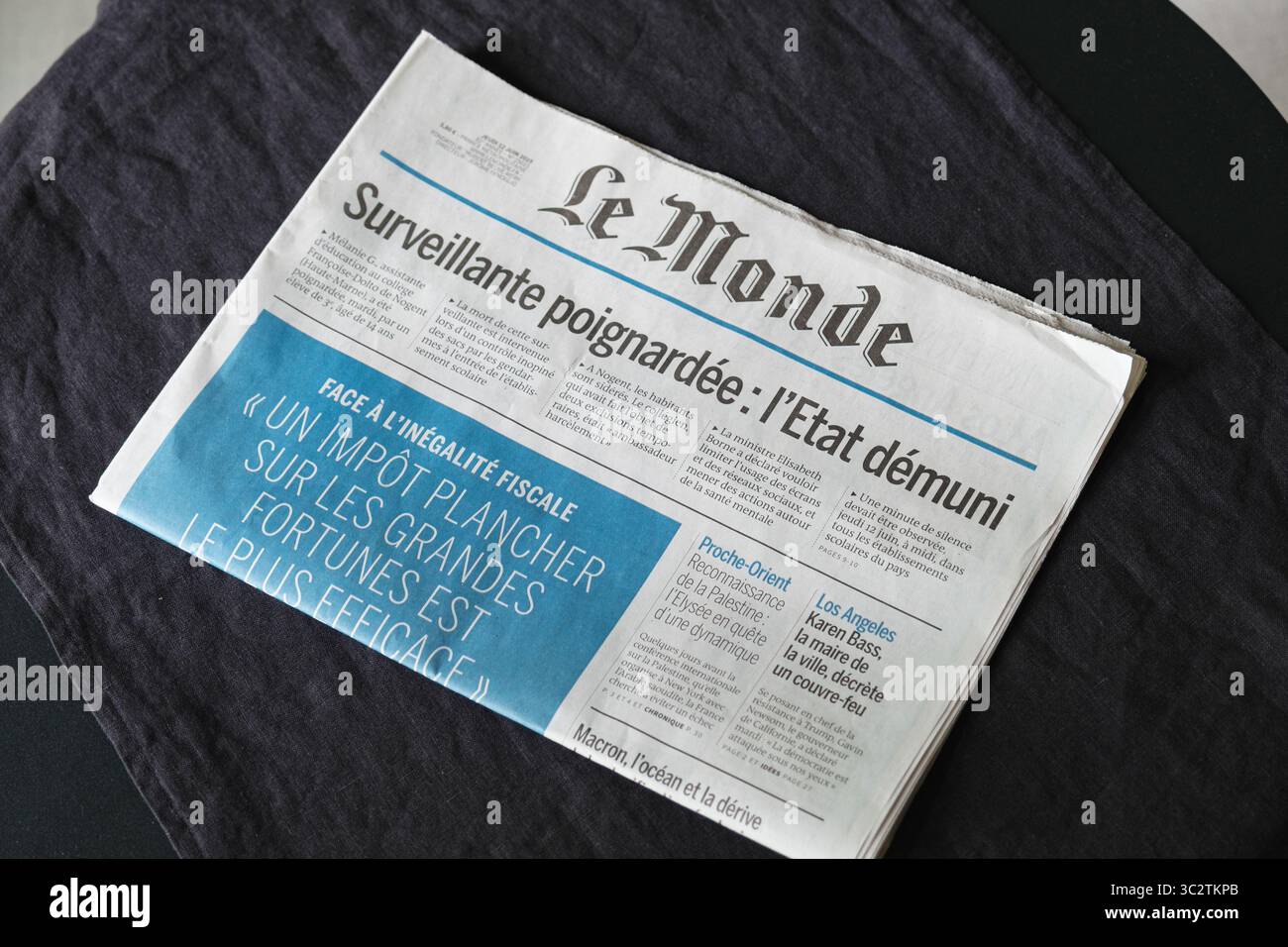 French newspaper Le Monde with bold headline on dark cloth Stock Photo ...