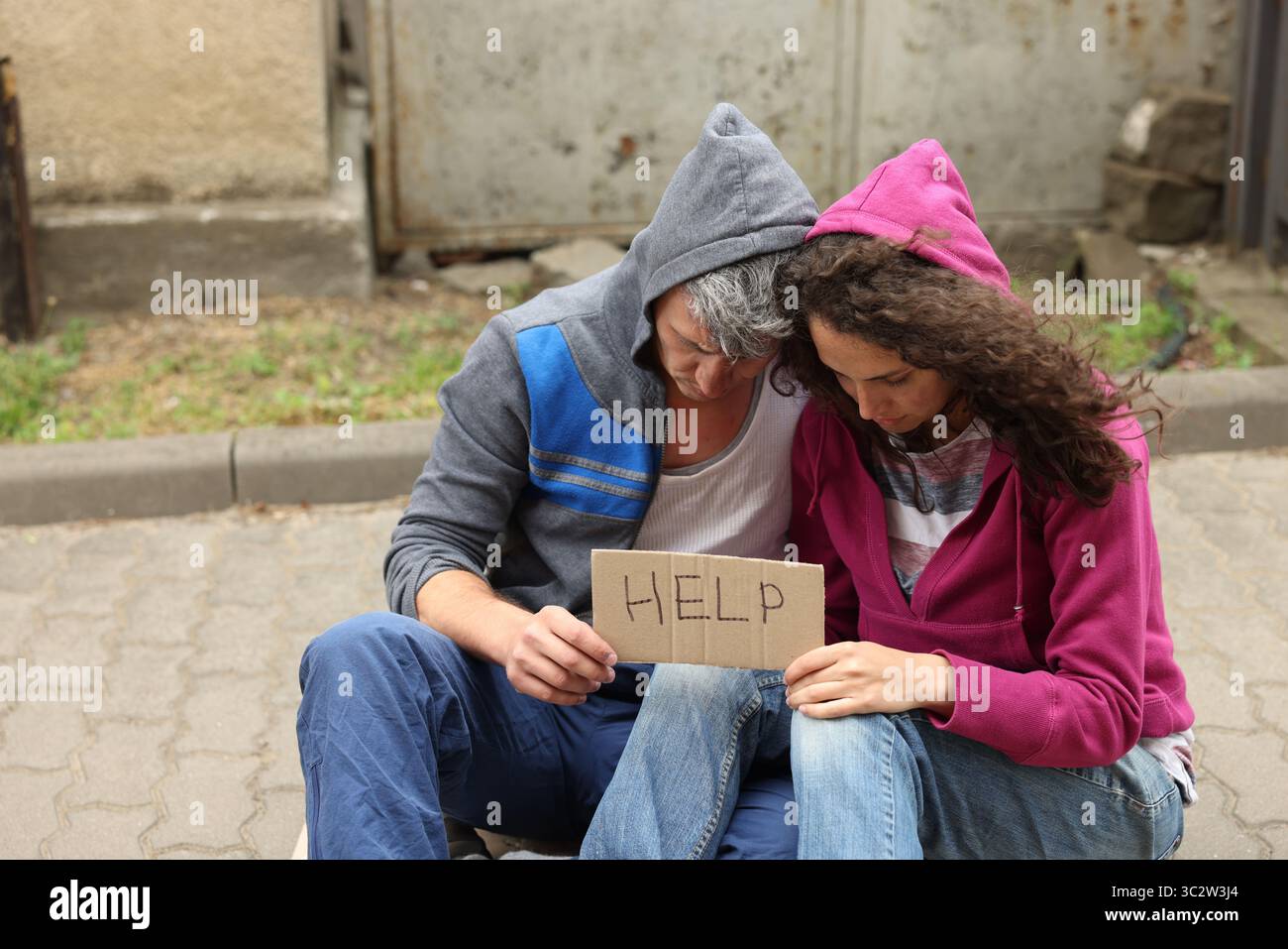 Poor homeless people with sign Help outdoors Stock Photo - Alamy