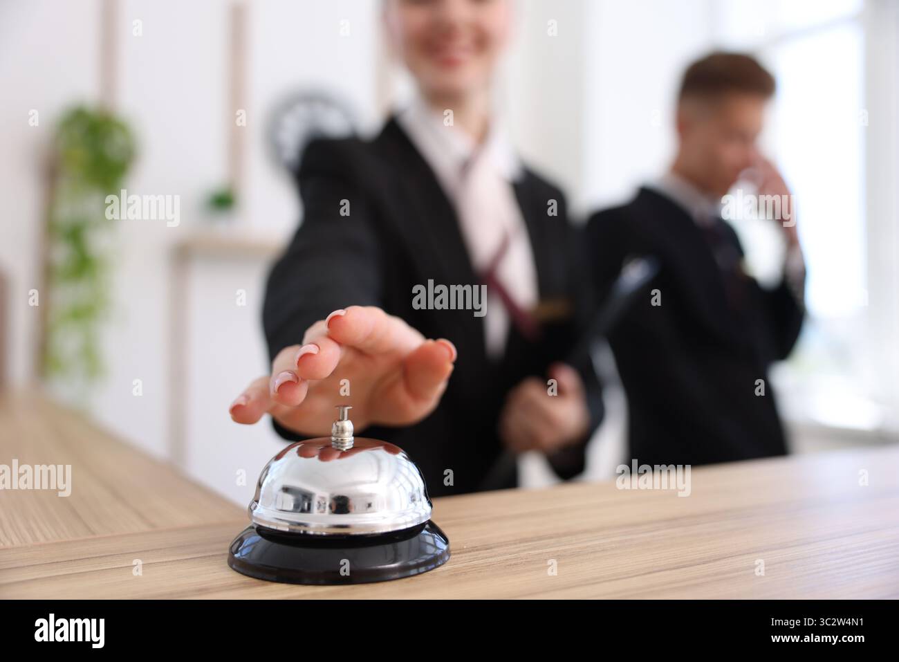 Client pushing service bell at reception desk in hotel, closeup Stock ...