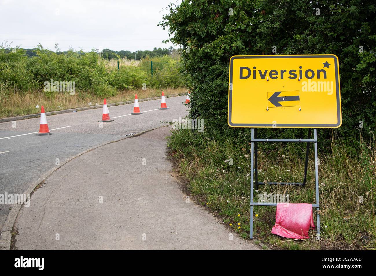 Yellow "Diversion" sign with a black arrow pointing left, positioned by ...