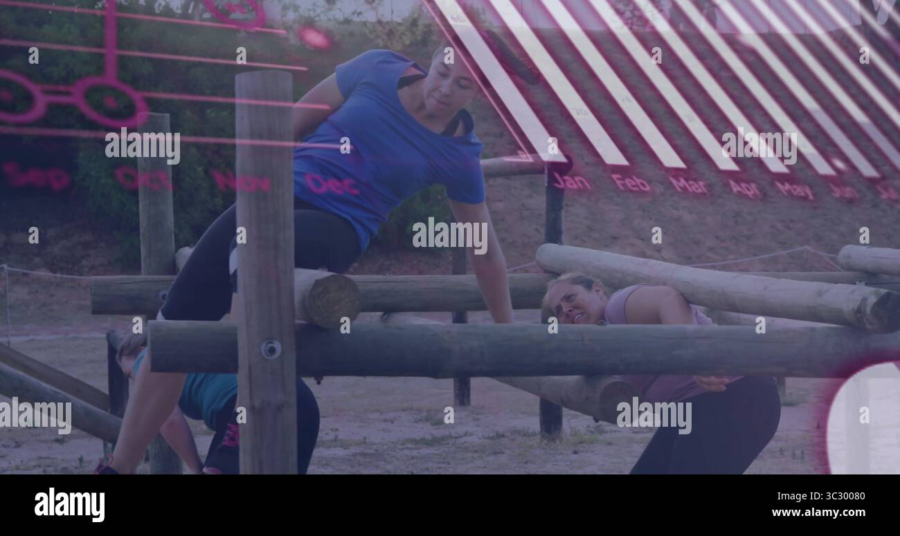 Climbing woman in blue shirt and leggings over beam on dirt obstacle ...