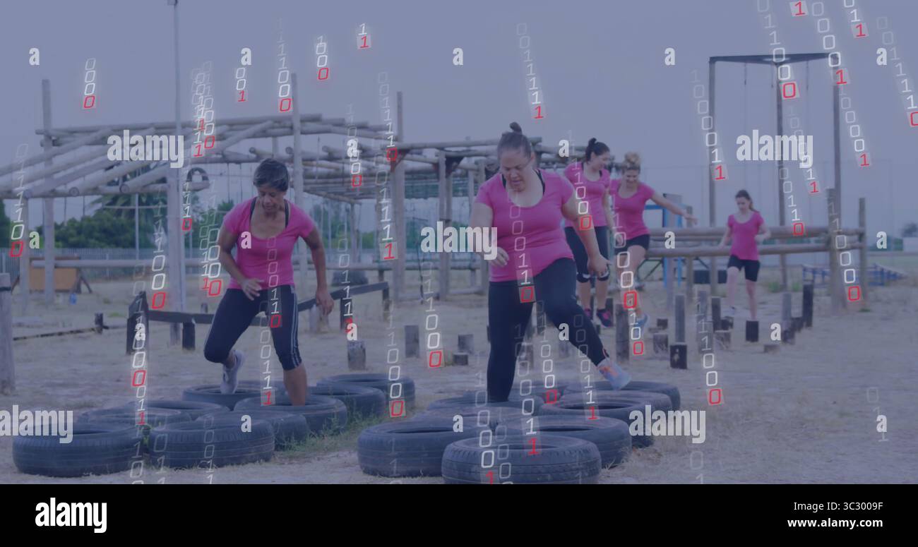 Group of six women in pink tops stepping through tires in outdoor ...