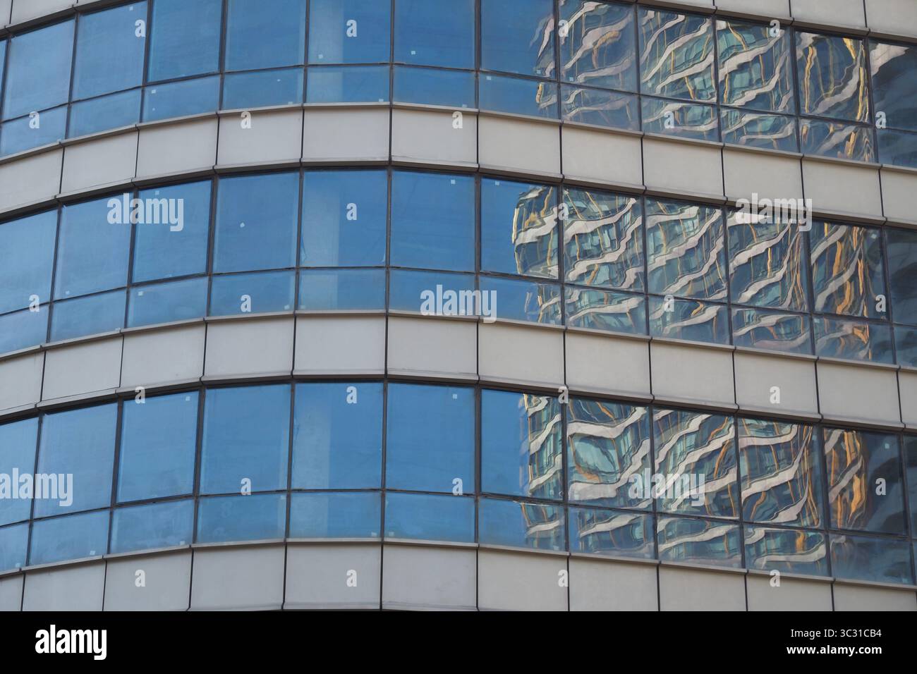 Reflective glass building shows neighboring architecture Stock Photo ...