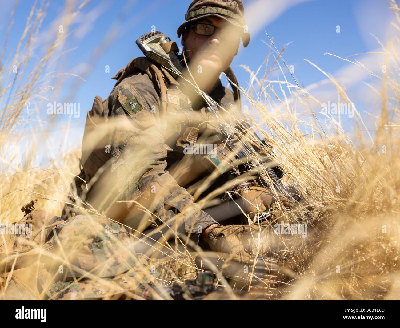 U.S. Marine Corps Cpl. Gabriel Stoy, right, a team leader, holds a belt ...