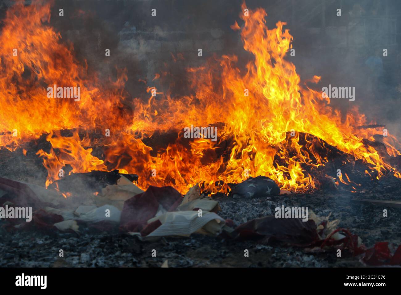 Flags burn during a somber ceremony at the Spanish Fork City Fiesta ...