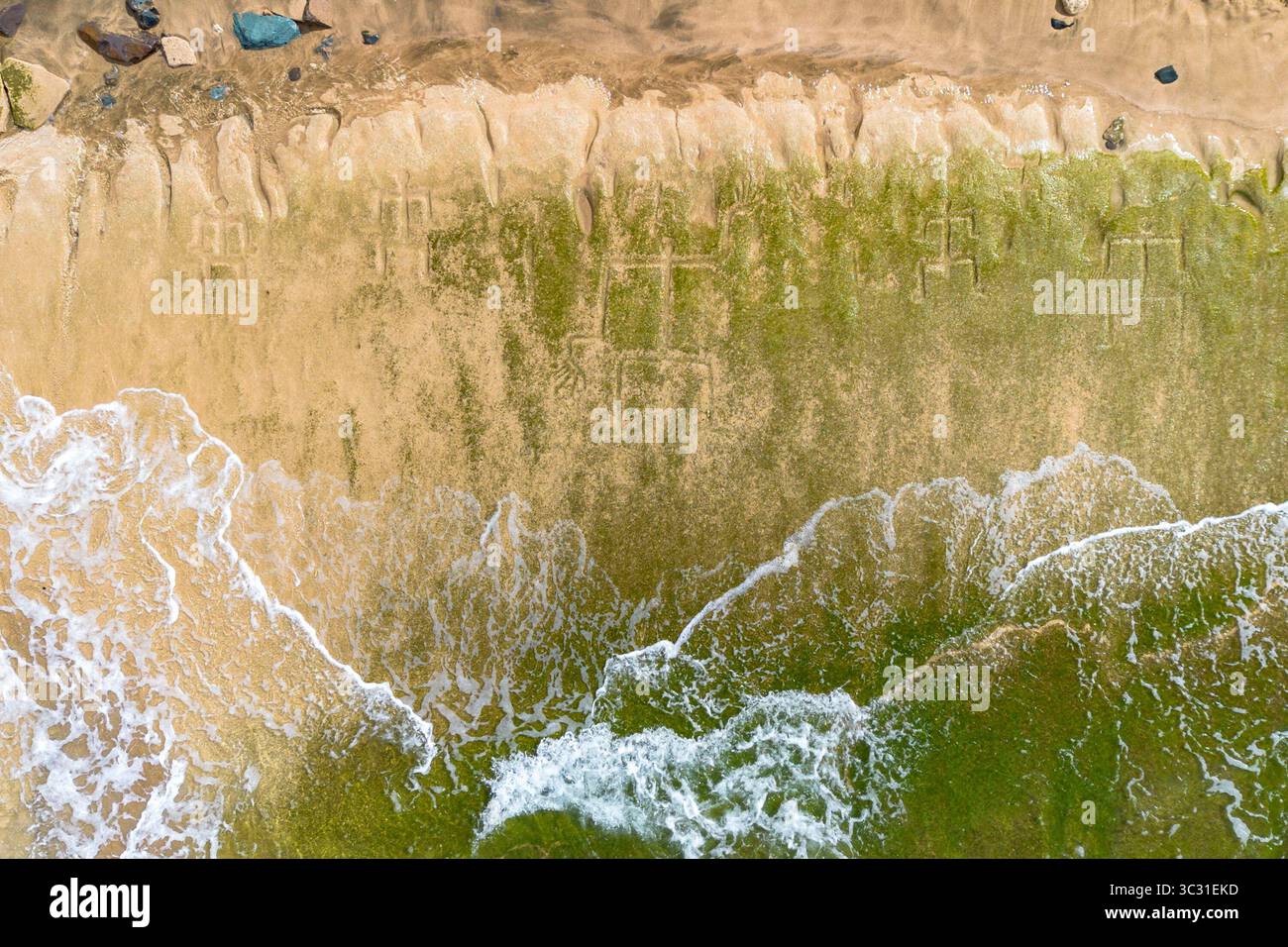 A drone view shows petroglyphs carved into the rock surface at Pokai ...