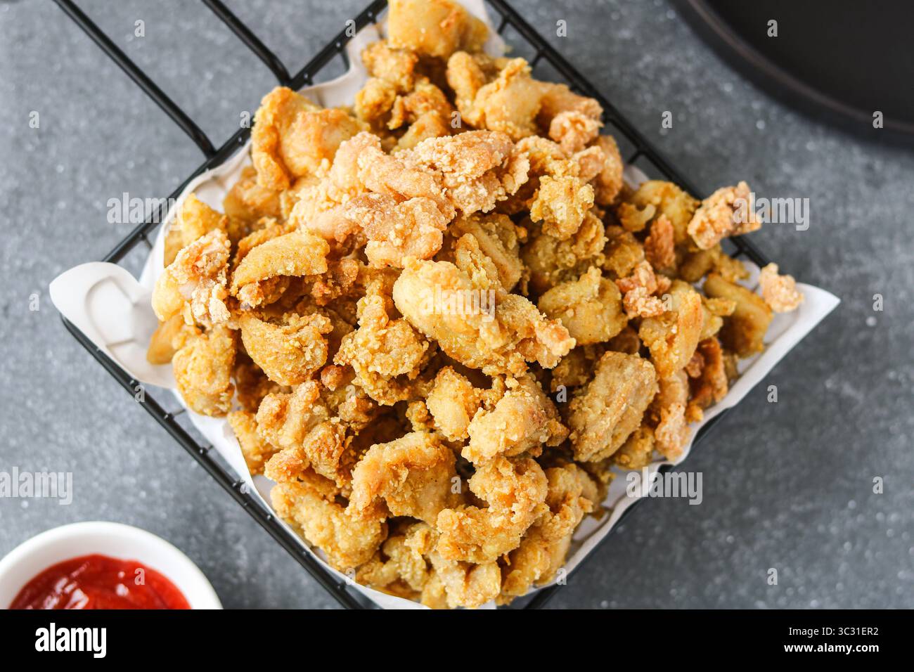 Top view of golden-brown popcorn chicken or bite-sized fried chicken ...