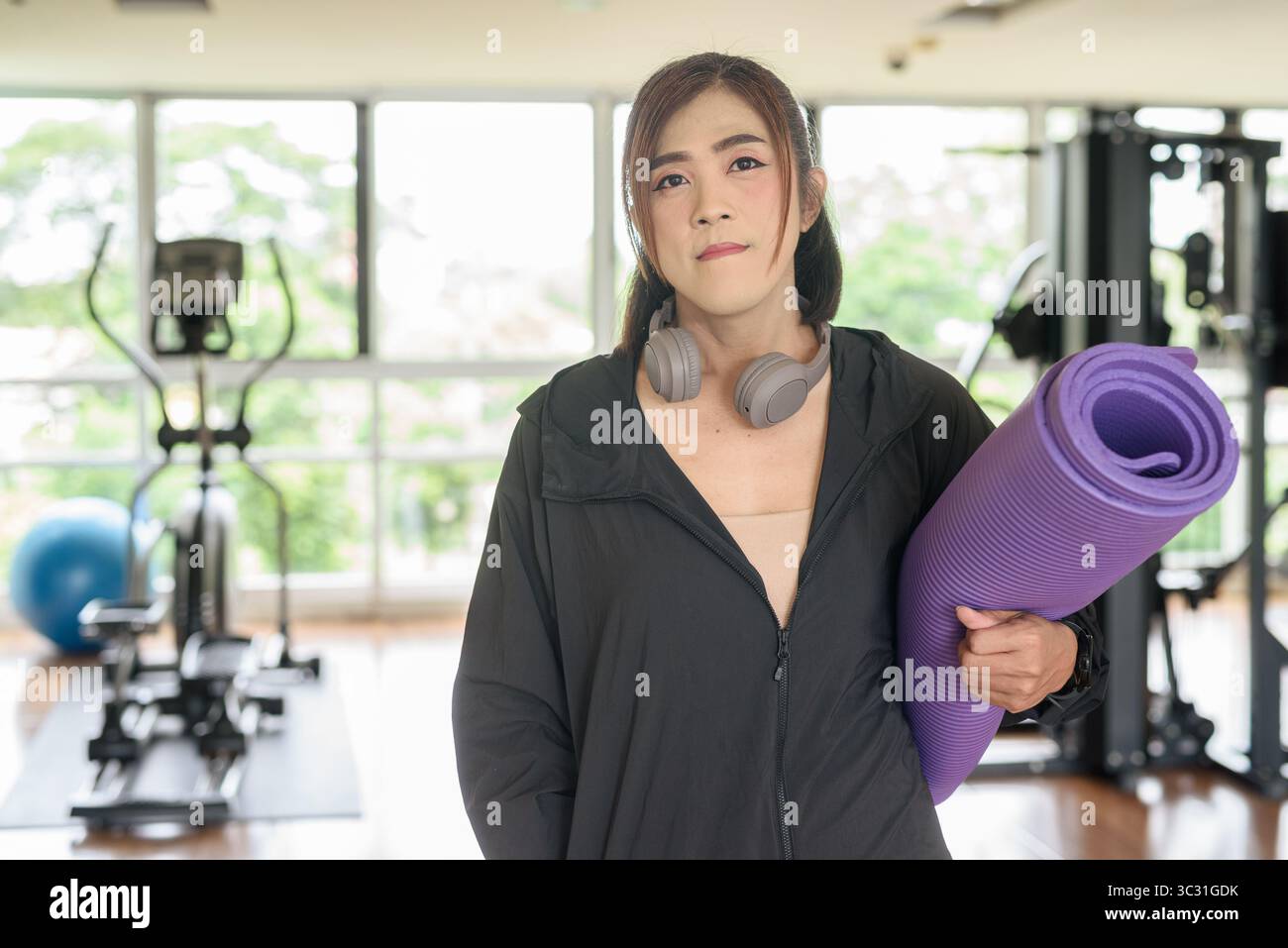 Attractive Asian transgender woman in gym environment training for ...