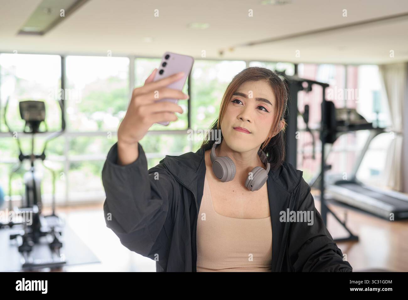 Attractive Asian transgender woman in gym environment training for ...