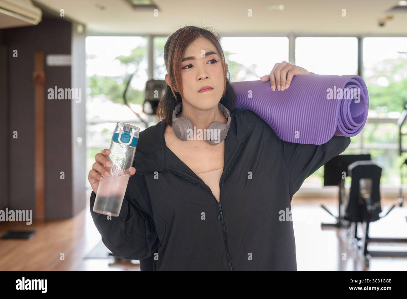 Attractive Asian transgender woman in gym environment training for ...