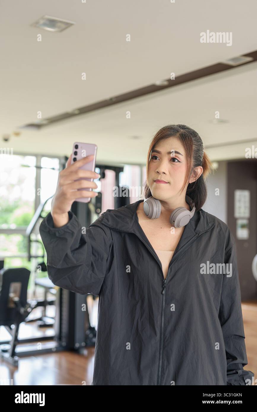 Attractive Asian transgender woman in gym environment training for ...