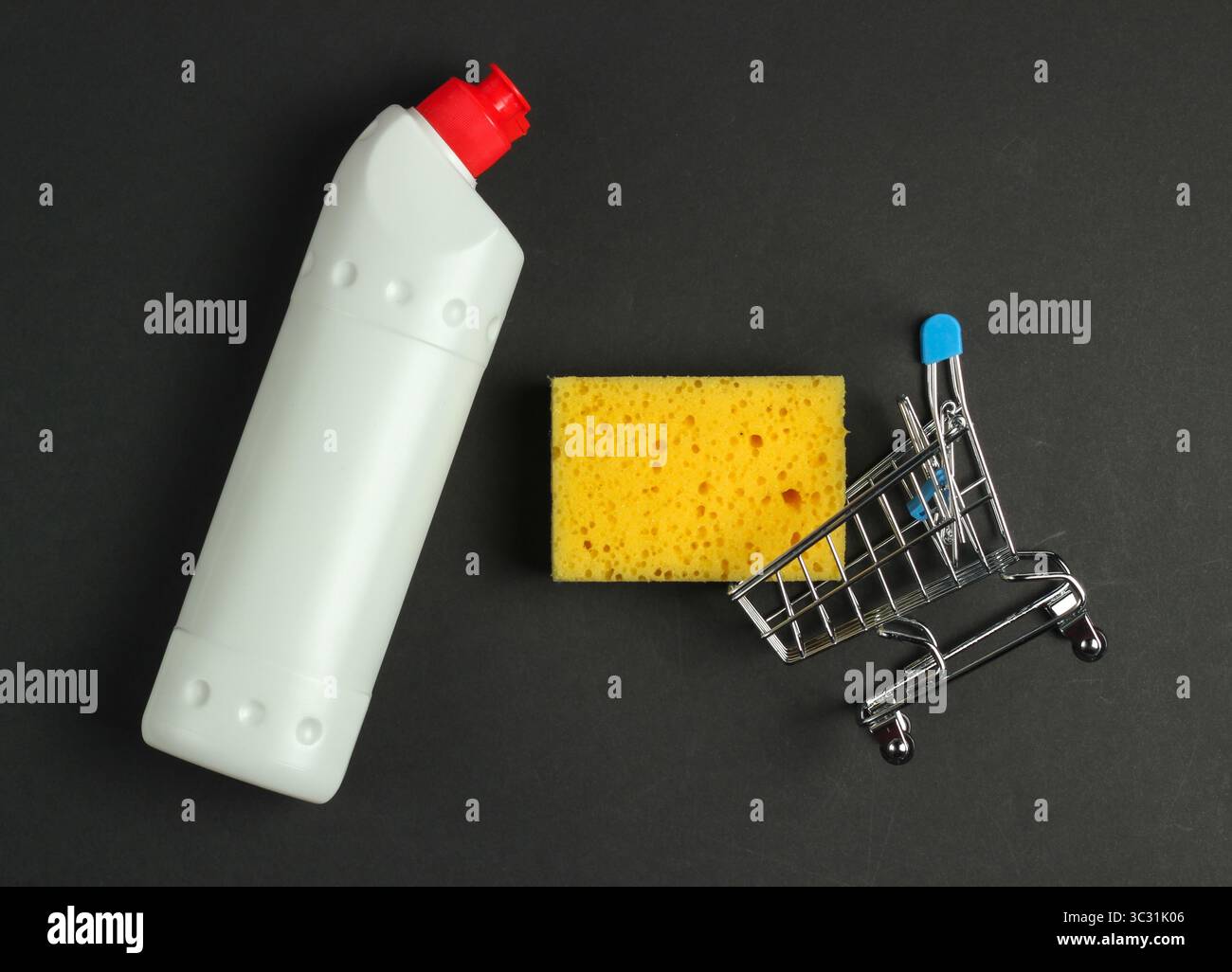 Cleaning concept. Shopping trolley with detergent bottle, sponge on ...