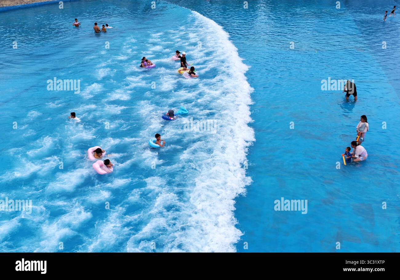 People play at a water park in Yangzhou City, east China's Jiangsu ...