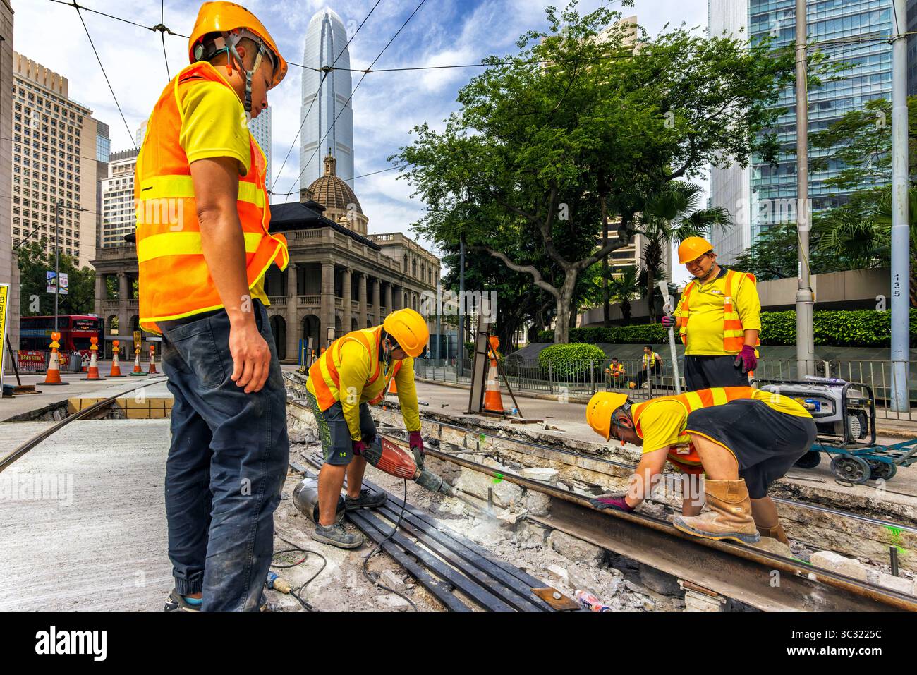 Construction workers repairing tram line keeping service running ...
