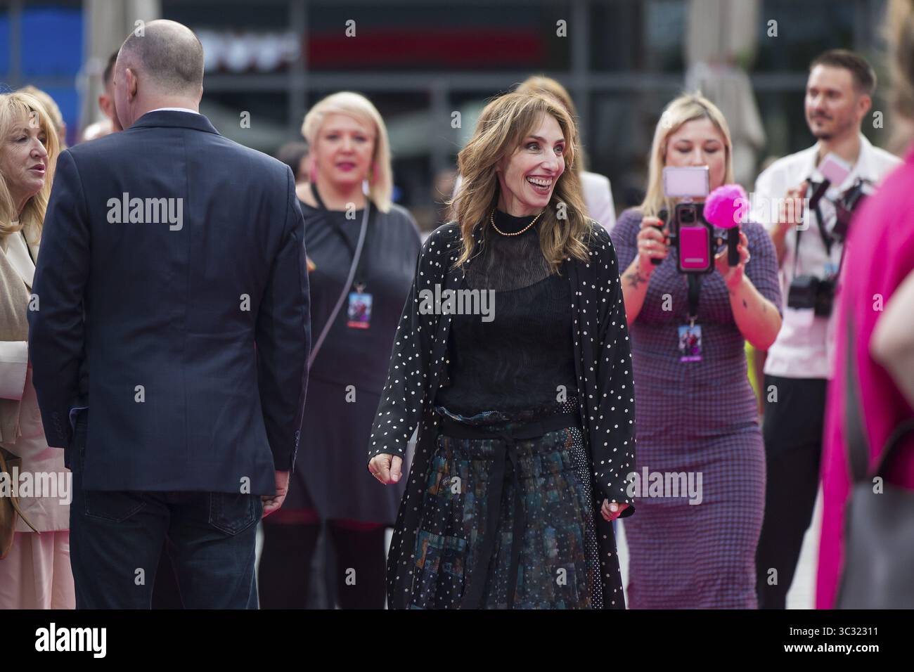 Erica Huggins (producer) in front of the film premiere of Die Nackte ...