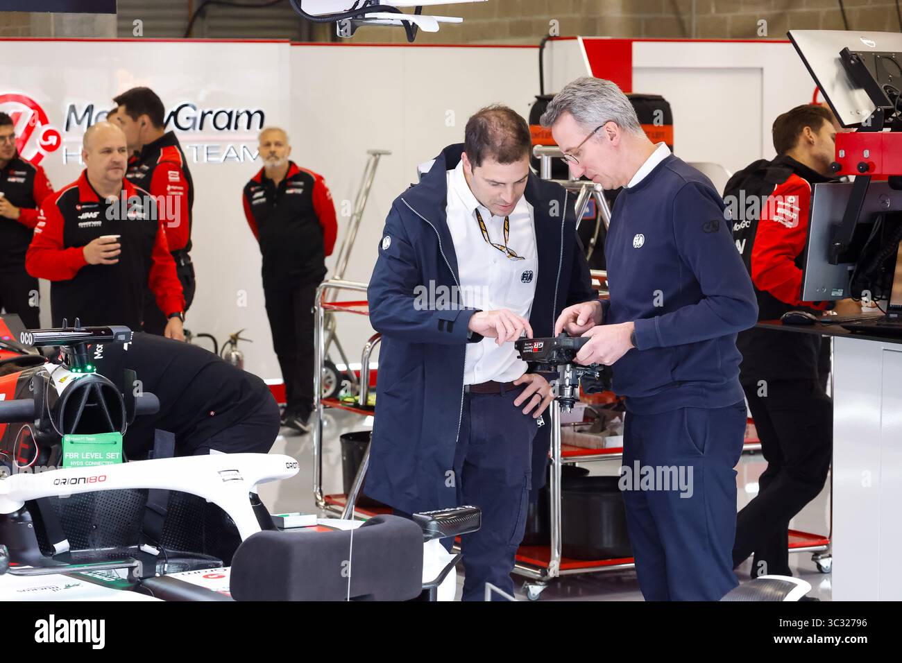 FIA staff at Haas F1 Team looking at steering wheel, volant, during the ...