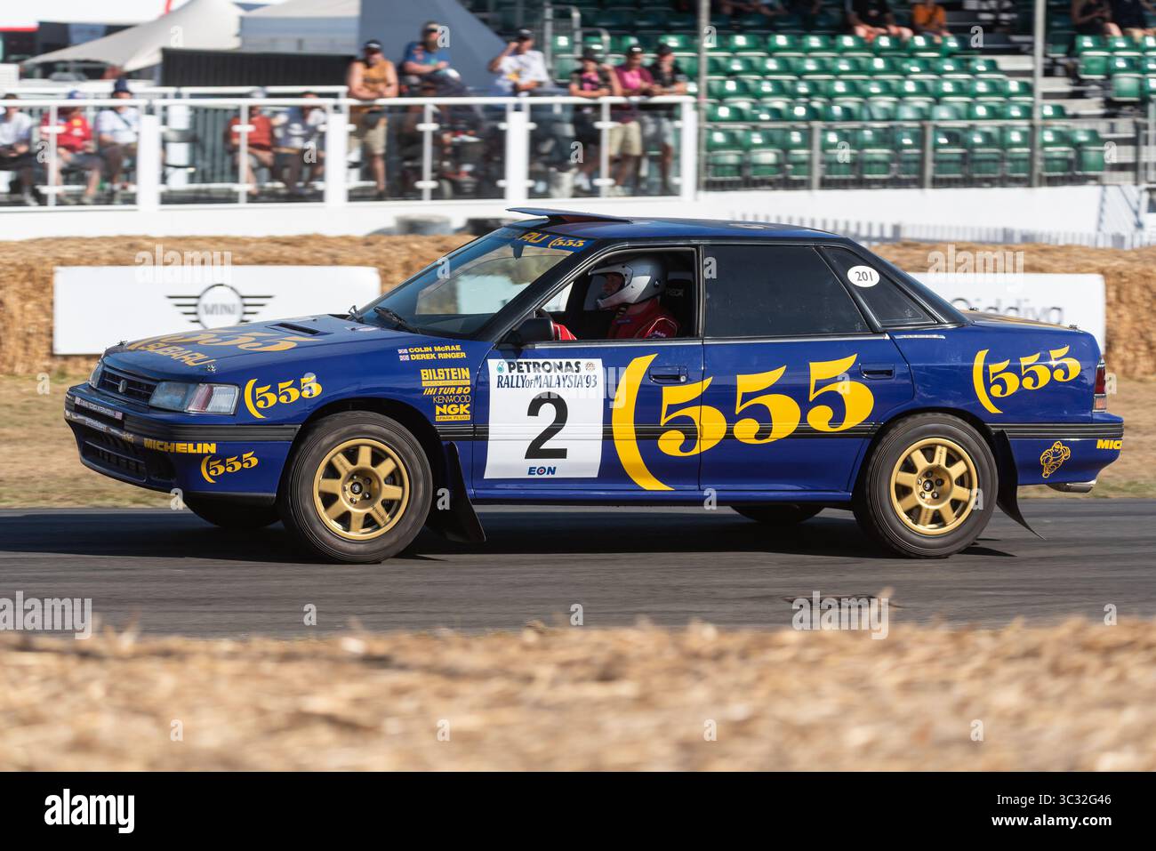1993 Subaru Legacy Group A rally car driving up the hillclimb track at ...