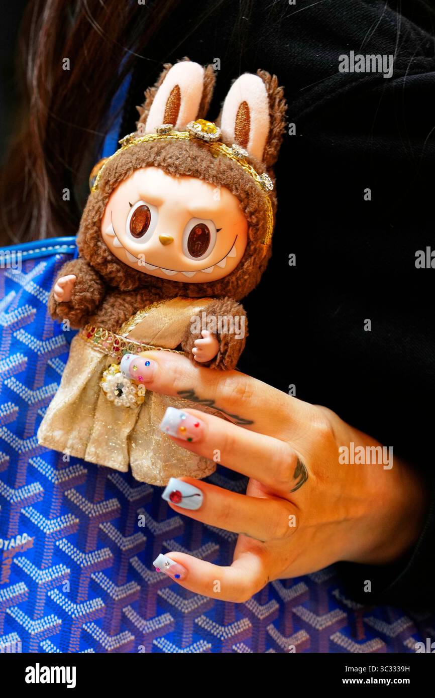 Diep Nguyen shows a Labubu doll to media during the opening of Germany ...