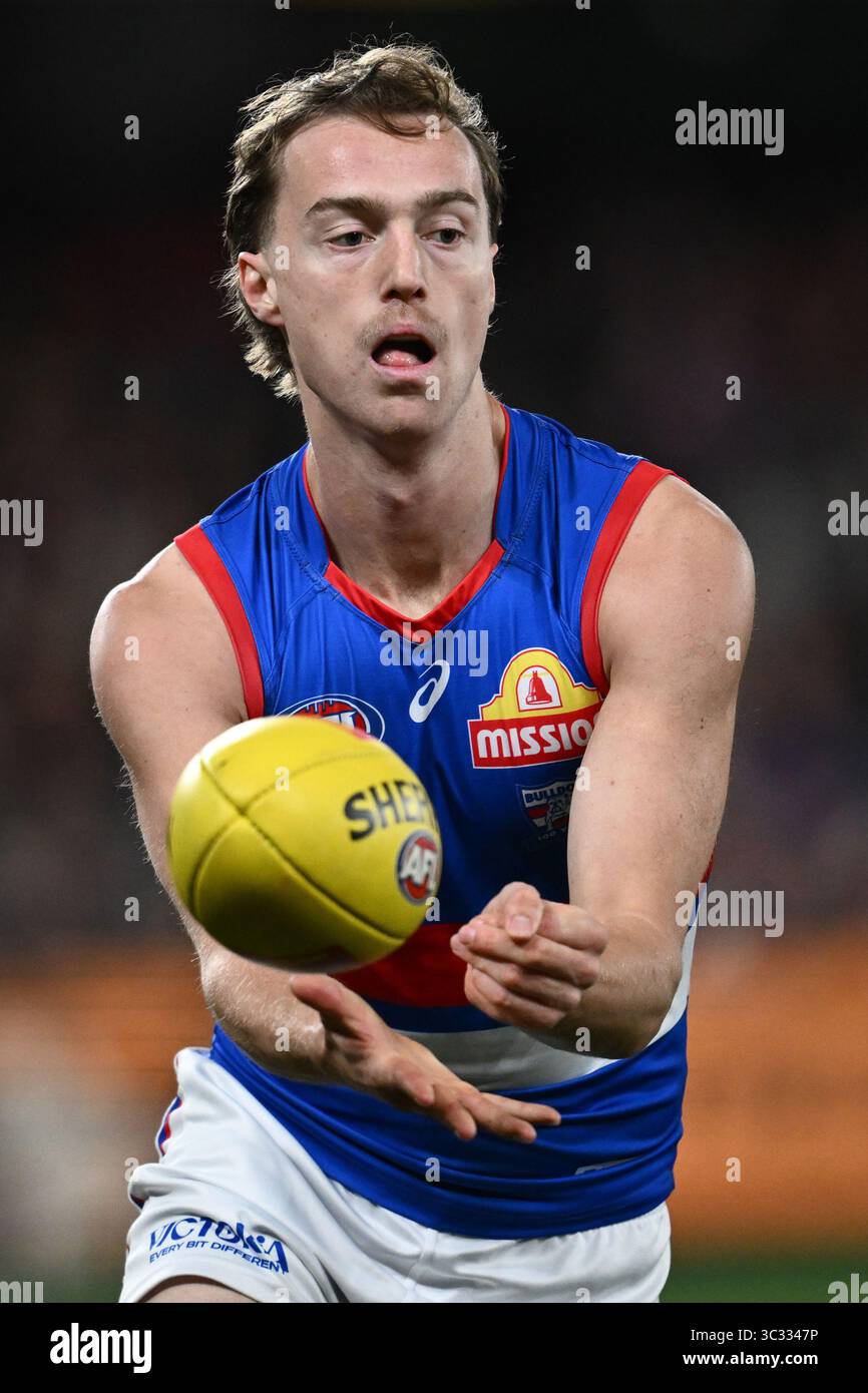Luke Cleary of Western Bulldogs handballs during the AFL Round 20 match ...