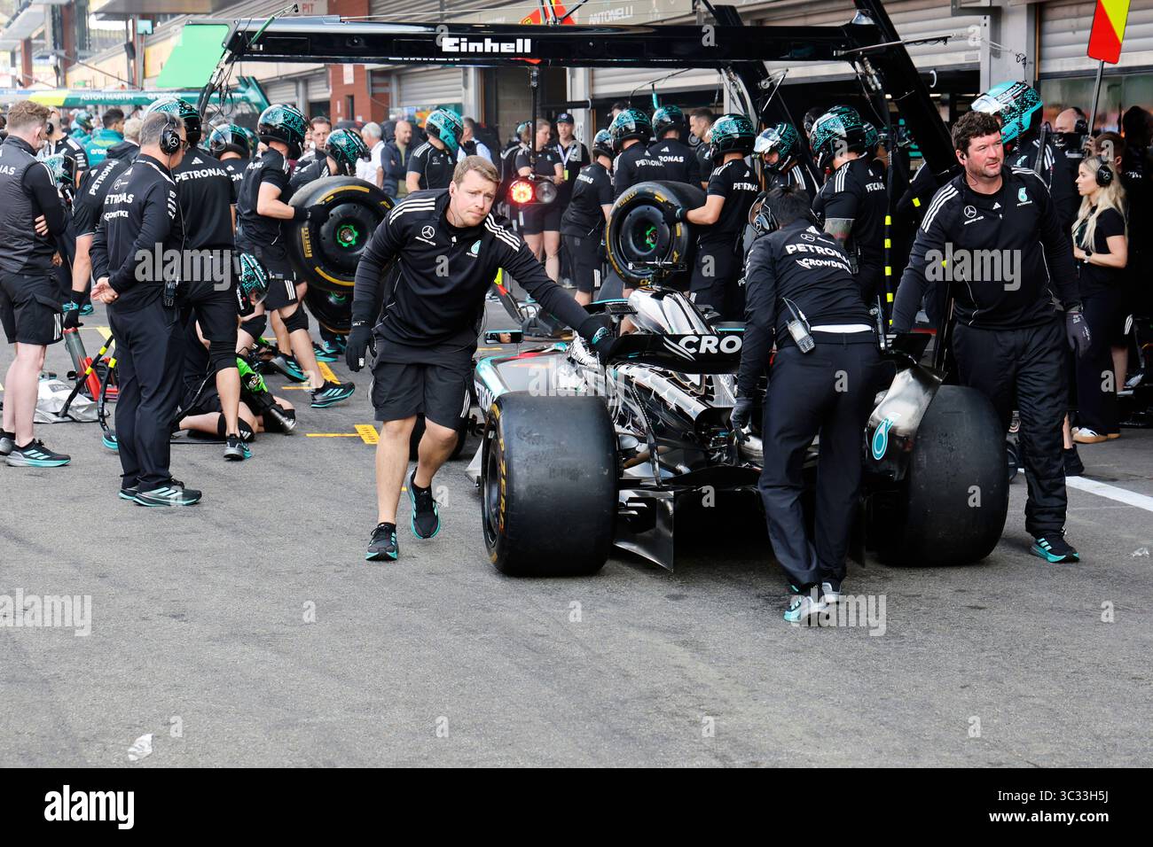 Mercedes crew work outside the team garage prior to the first practice ...