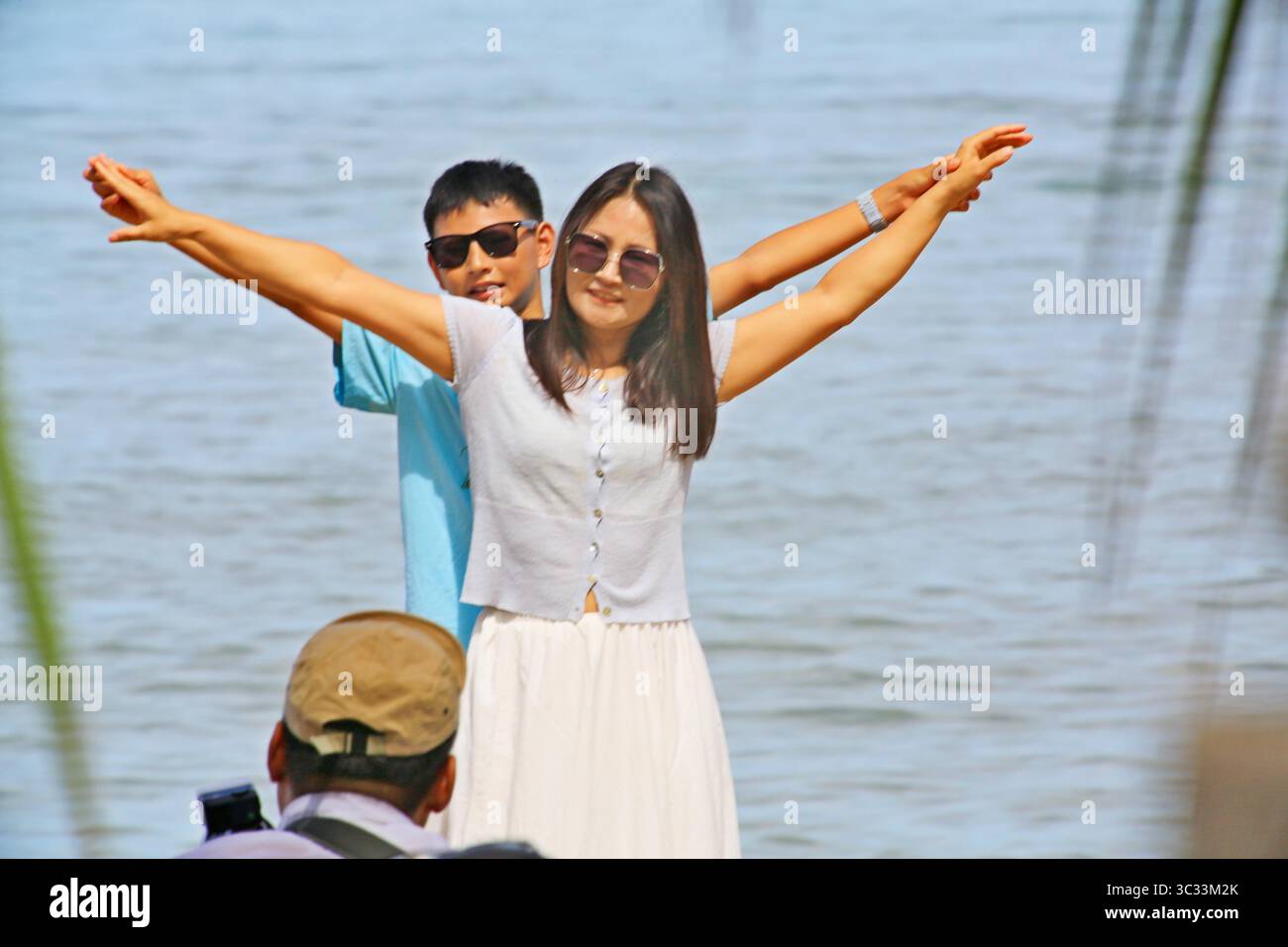 Tourists play at the seaside in Sanya City, southernmost China's Hainan ...