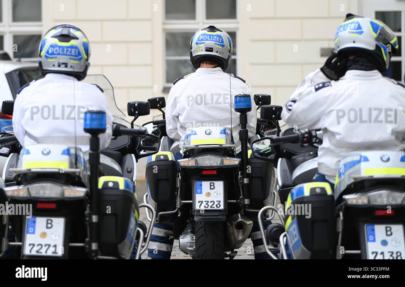 22 July 2025, Berlin: Police officers from the motorcycle squadron ...
