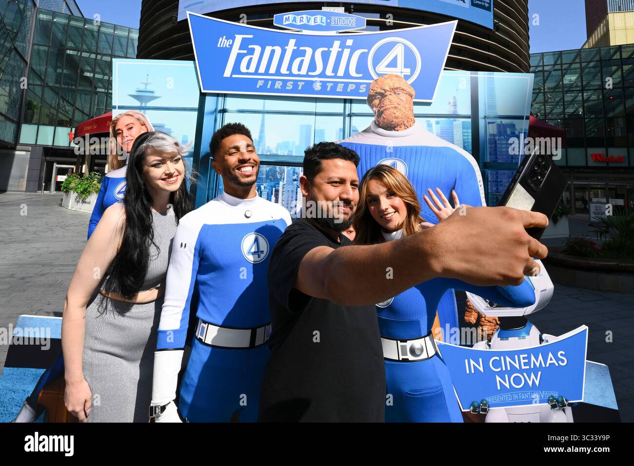 EDITORIAL USE ONLY Mahmud Alam getting a photo taken with cosplayers ...