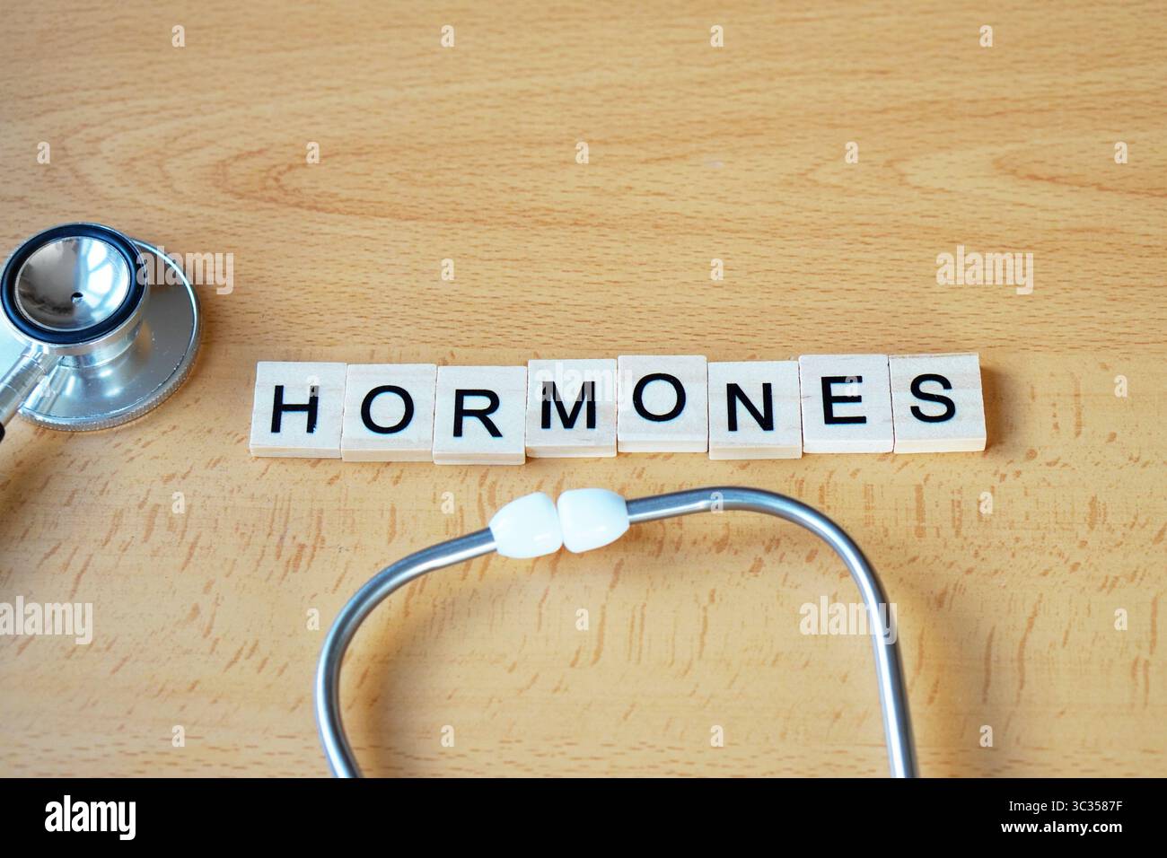 medical concepts. hormones. word written in wooden letters next to a ...