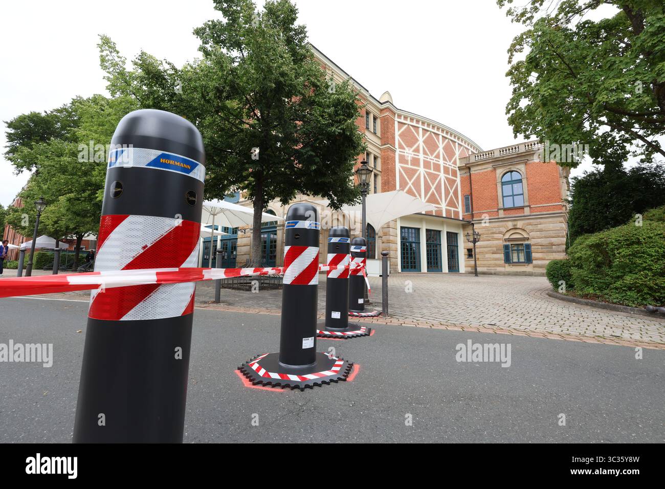 24 July 2025, Bavaria, Bayreuth: Mobile security barriers are in place ...