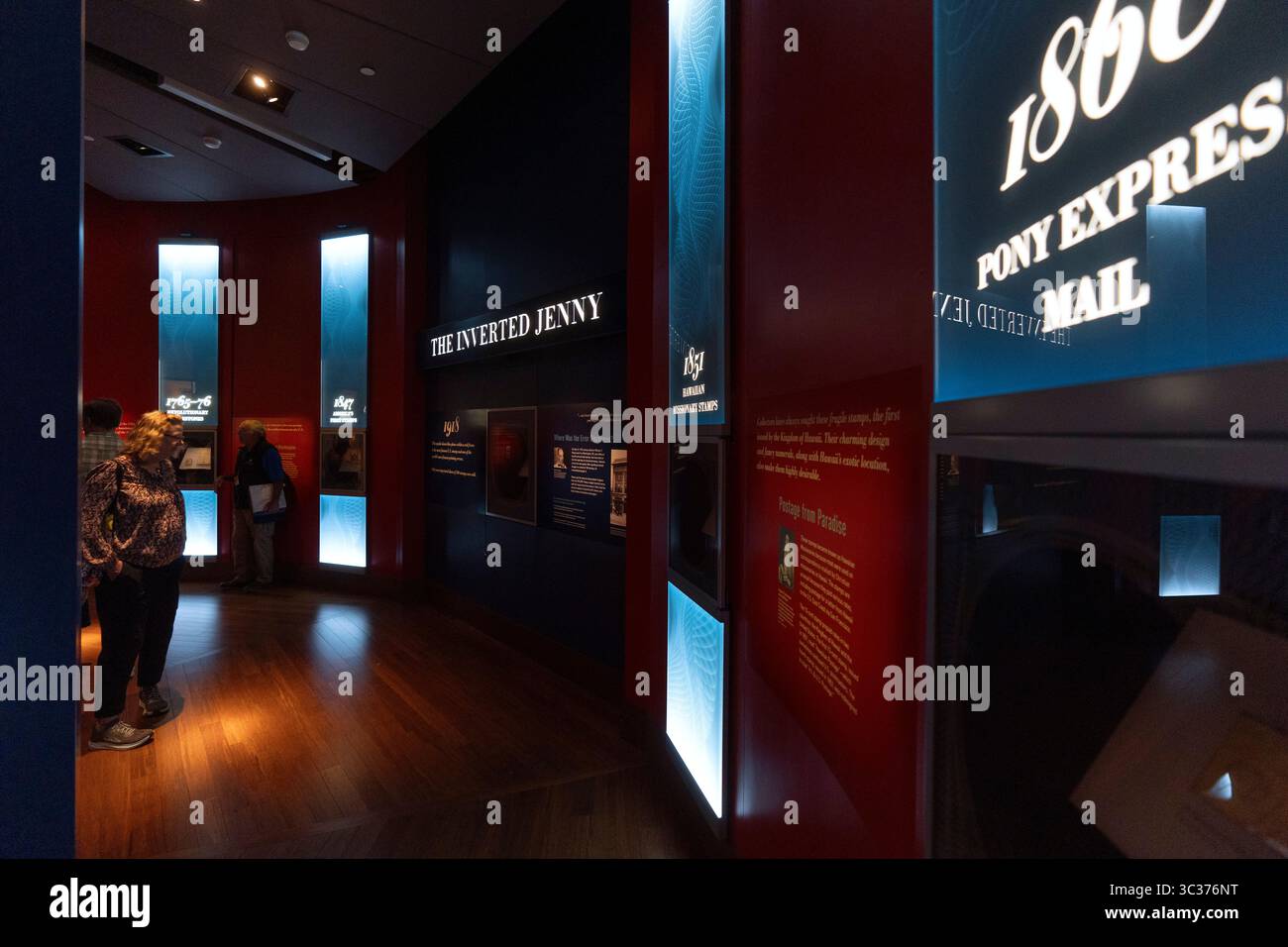 Visitors look at rare stamps and postal artifacts in a gallery at the ...