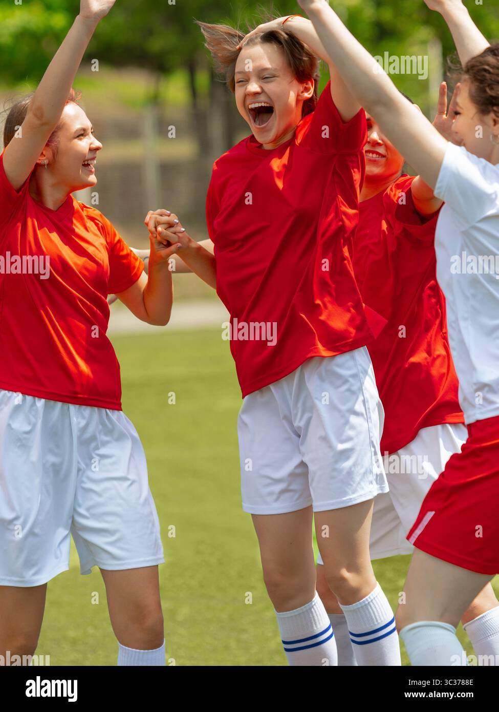 Female soccer players rejoice with passionate hug after winning on ...