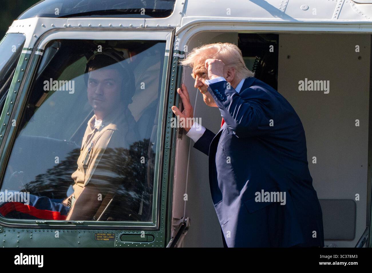 President Donald Trump pumps his fist before departing on Marine One ...