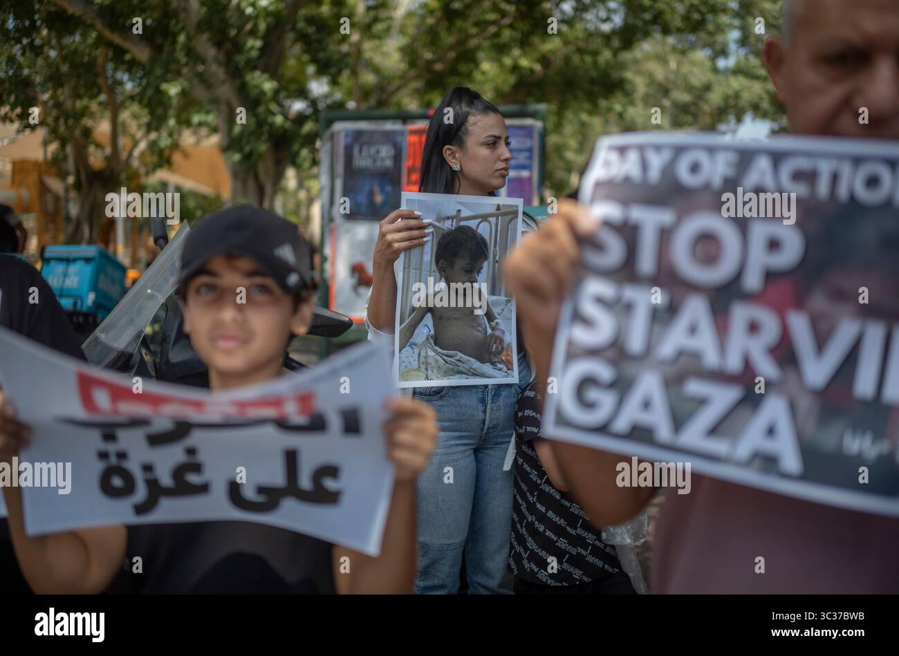 25 July 2025, Israel, Tel Aviv: People hold placards during a protest ...