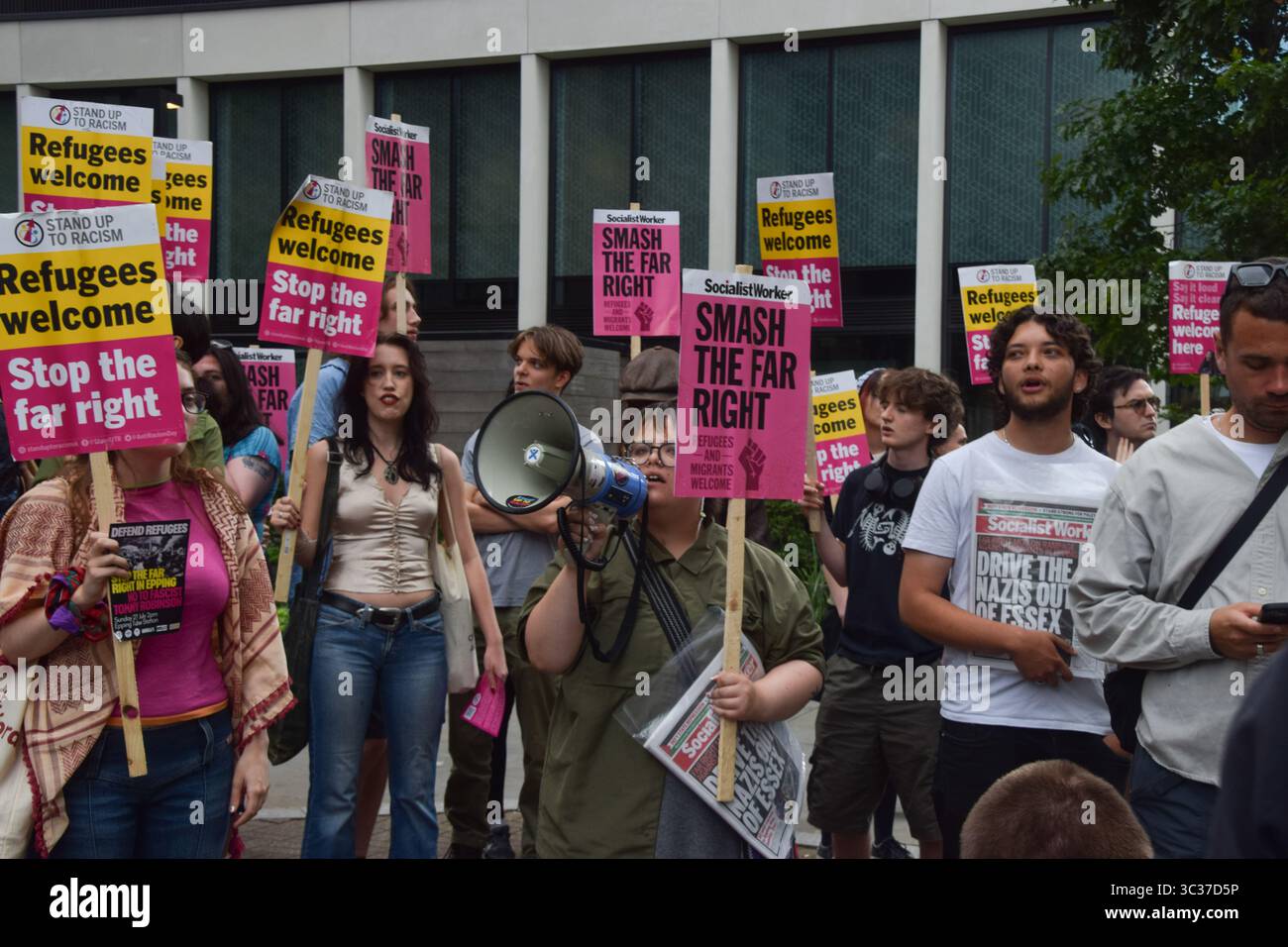 London, UK. 25th July 2025. Protesters holding Refugees Welcome ...