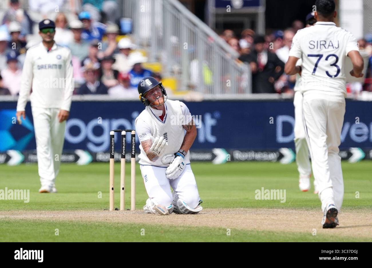 England's Ben Stokes reacts after taking a ball to the body during day ...
