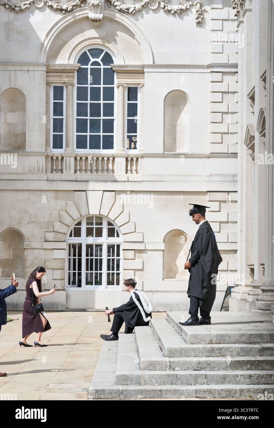 A student poses for a photo after his graduation ceremony at Senate ...