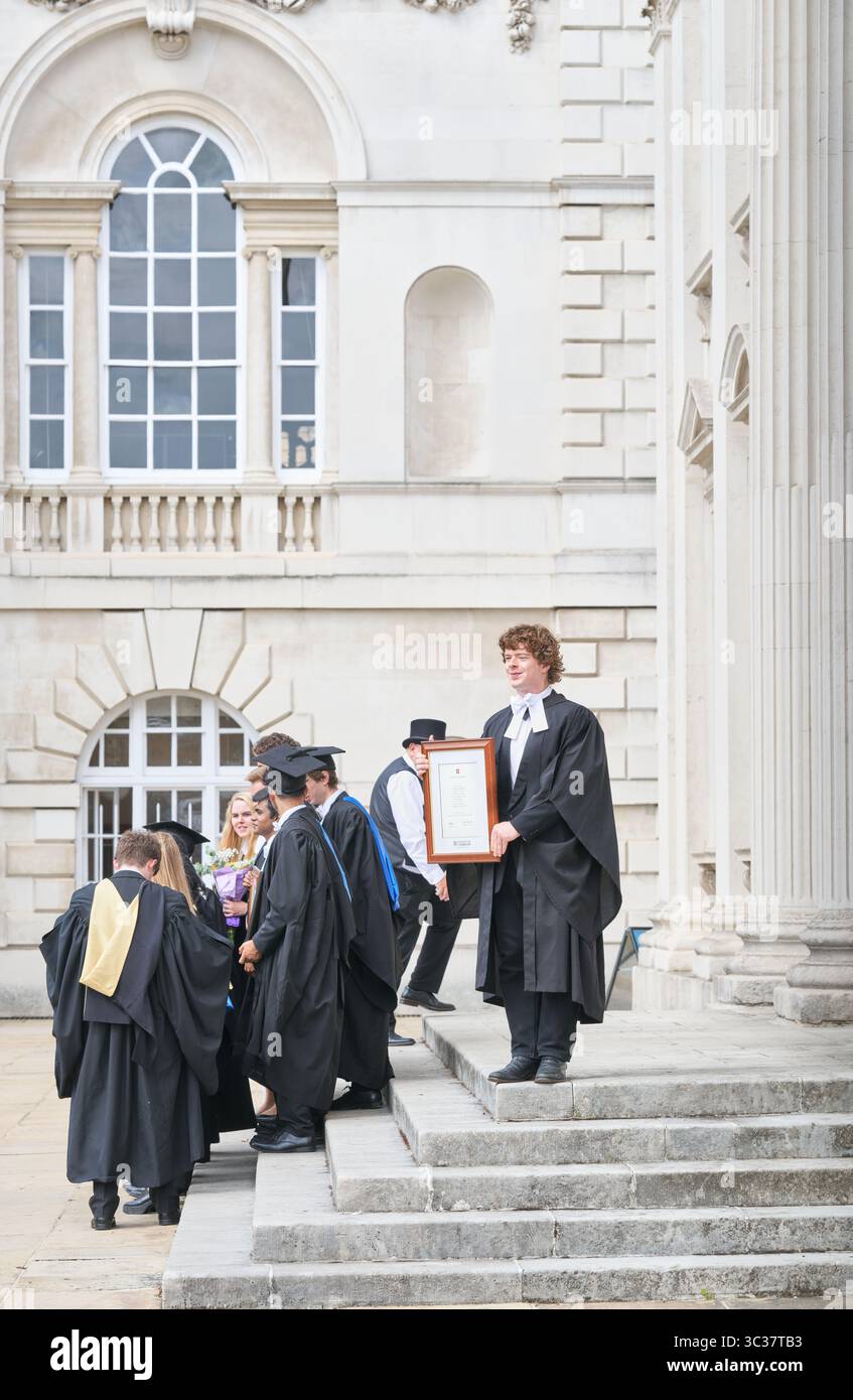 A student poses for a photo after his graduation ceremony in Senate ...