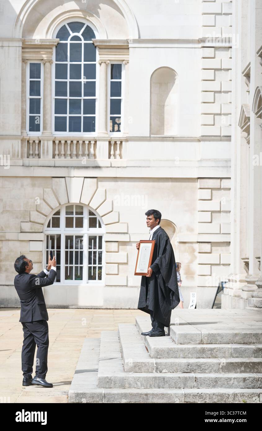 A student poses for a photo after his graduation ceremony in Senate ...