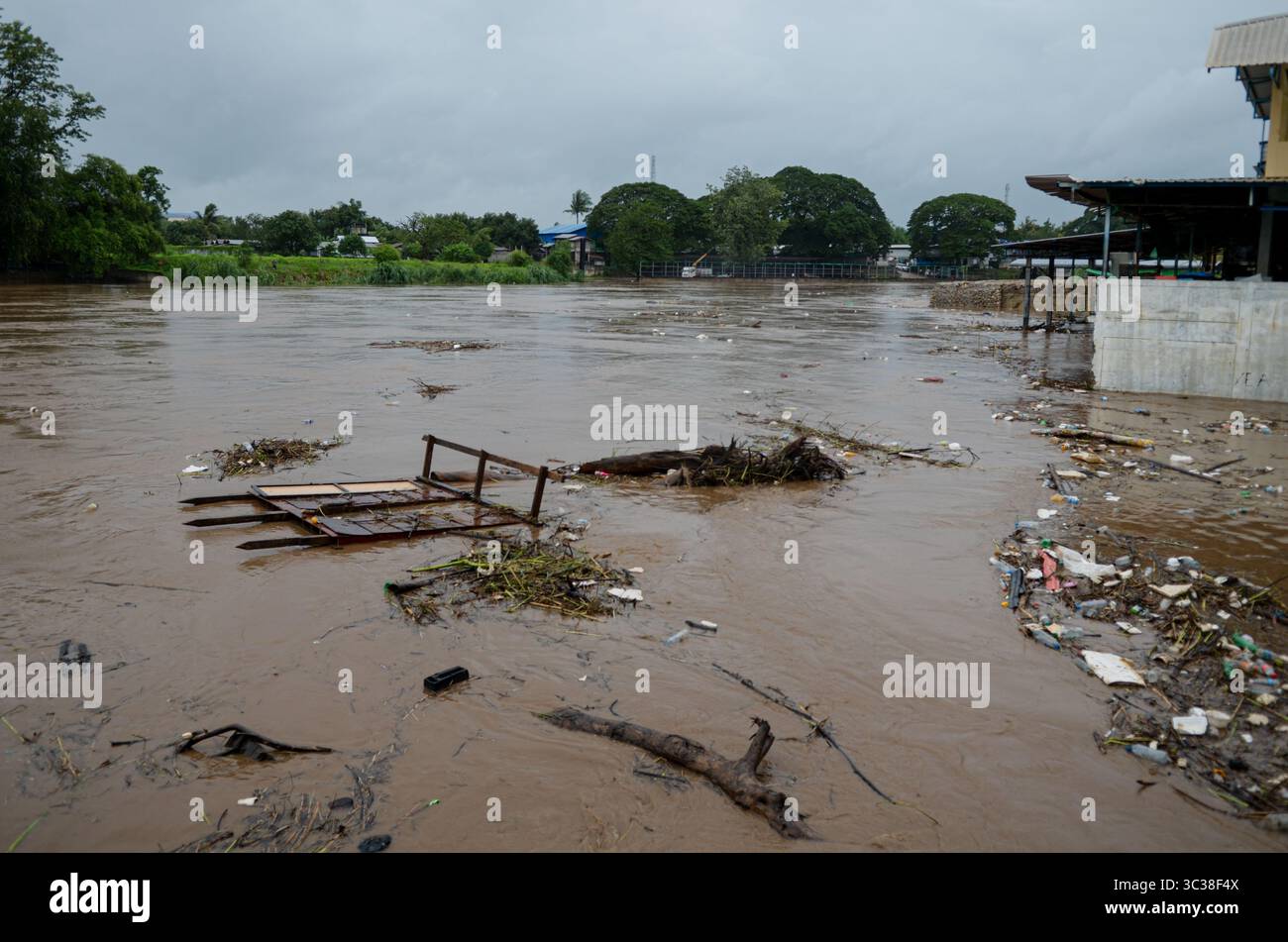 The swollen Moei River overflows its banks in Mae Sot, its muddy ...