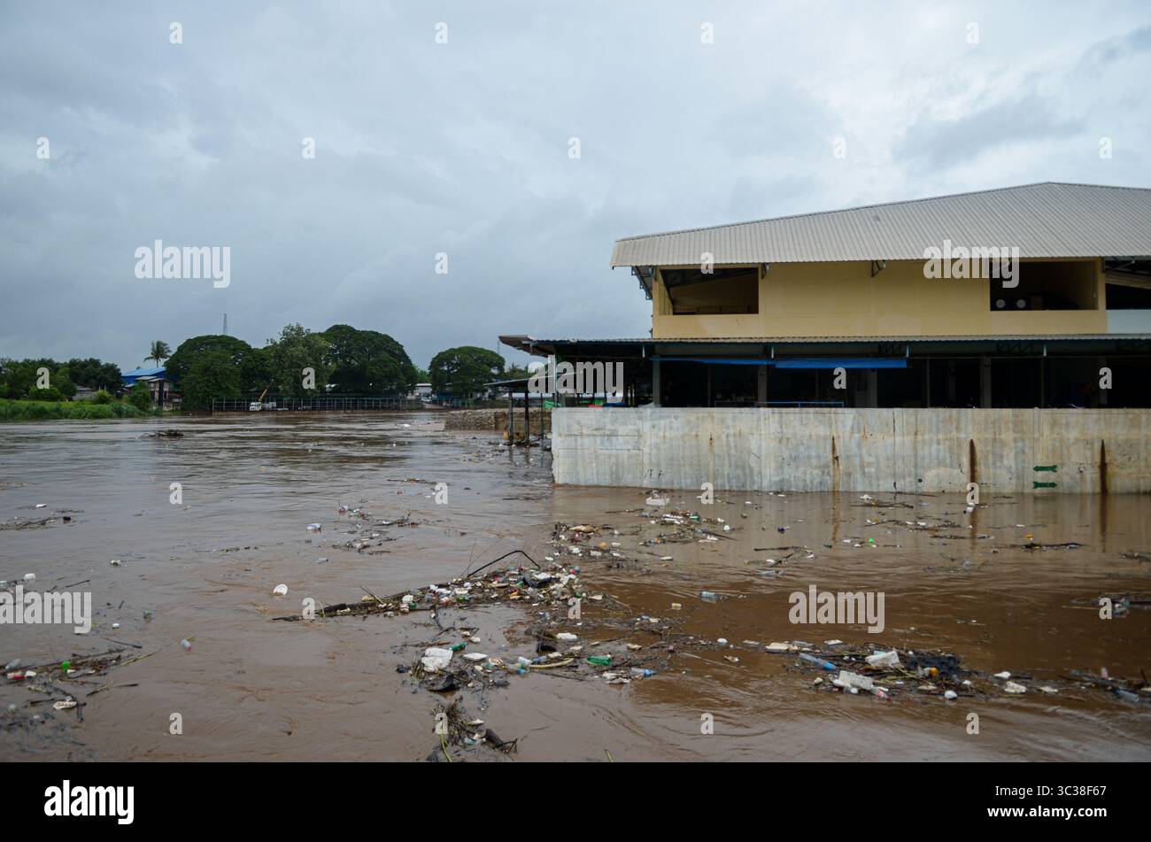 The swollen Moei River overflows its banks in Mae Sot, its muddy ...