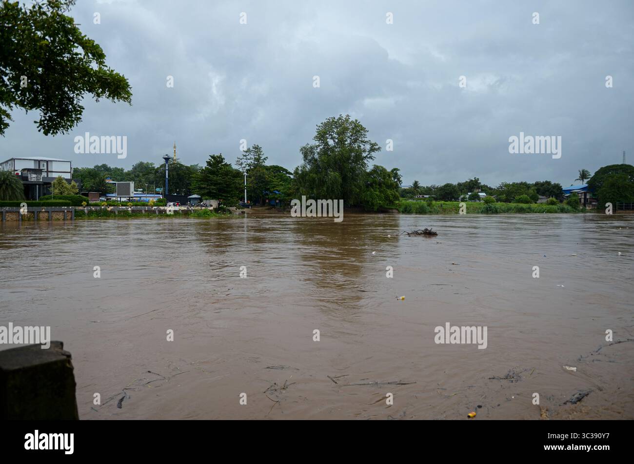 The swollen Moei River overflows its banks in Mae Sot, its muddy ...