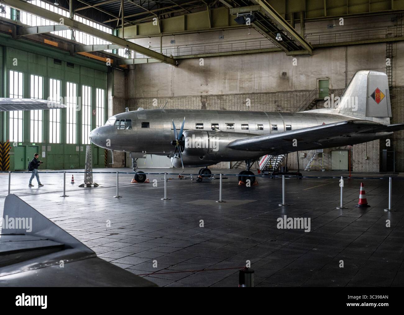 25 July 2025, Berlin: A man approaches a Russian Ilyushin Il-14 during ...