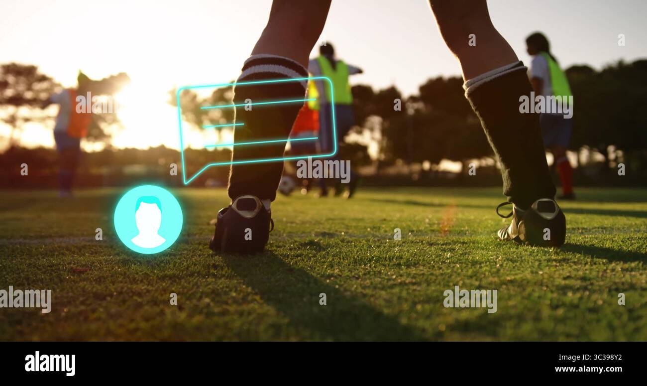 Highlighting soccer player standing over ball on grass field at sunset ...