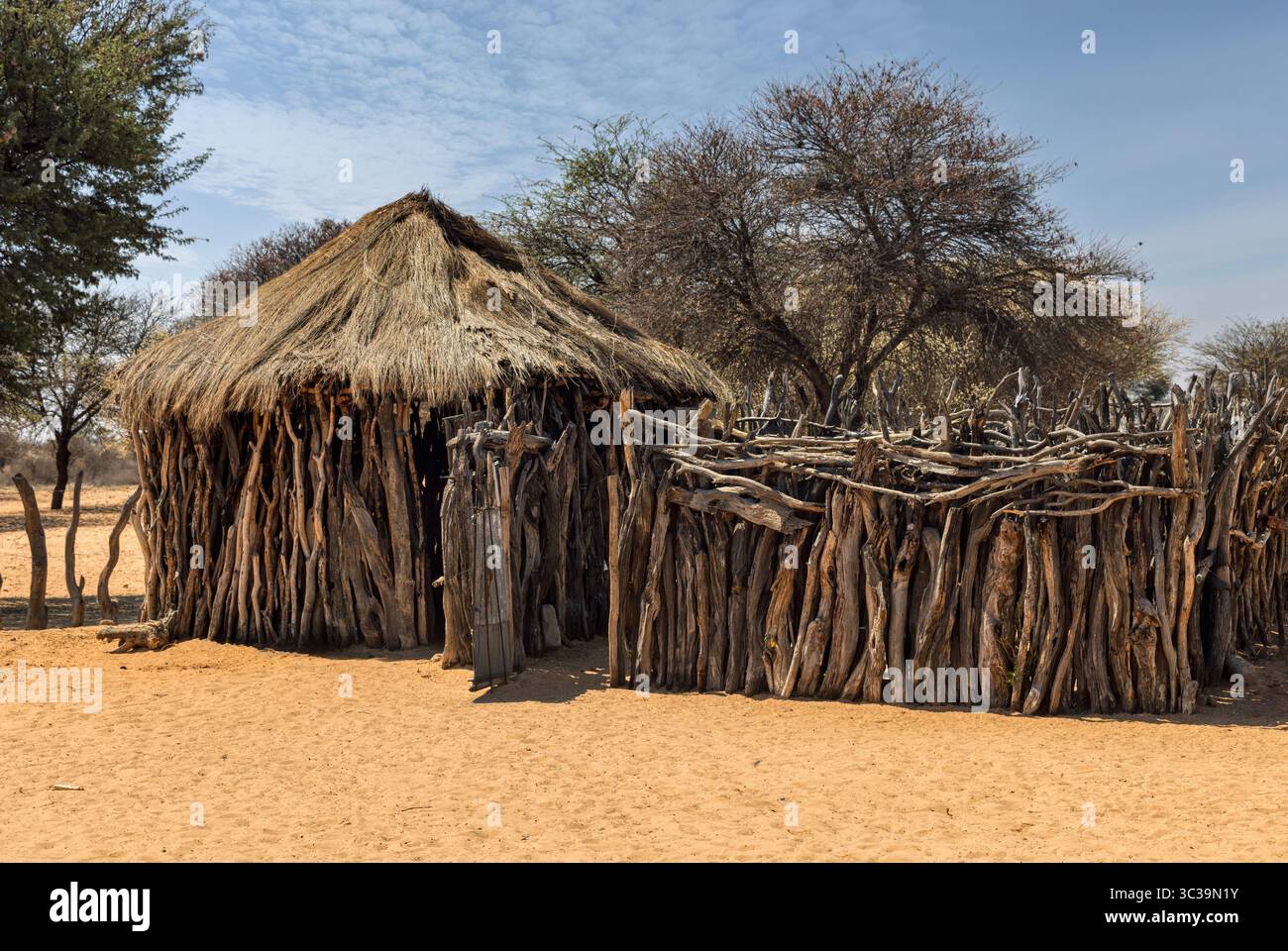 hut rondavel wood wall and fence with thatched roof, in African village ...