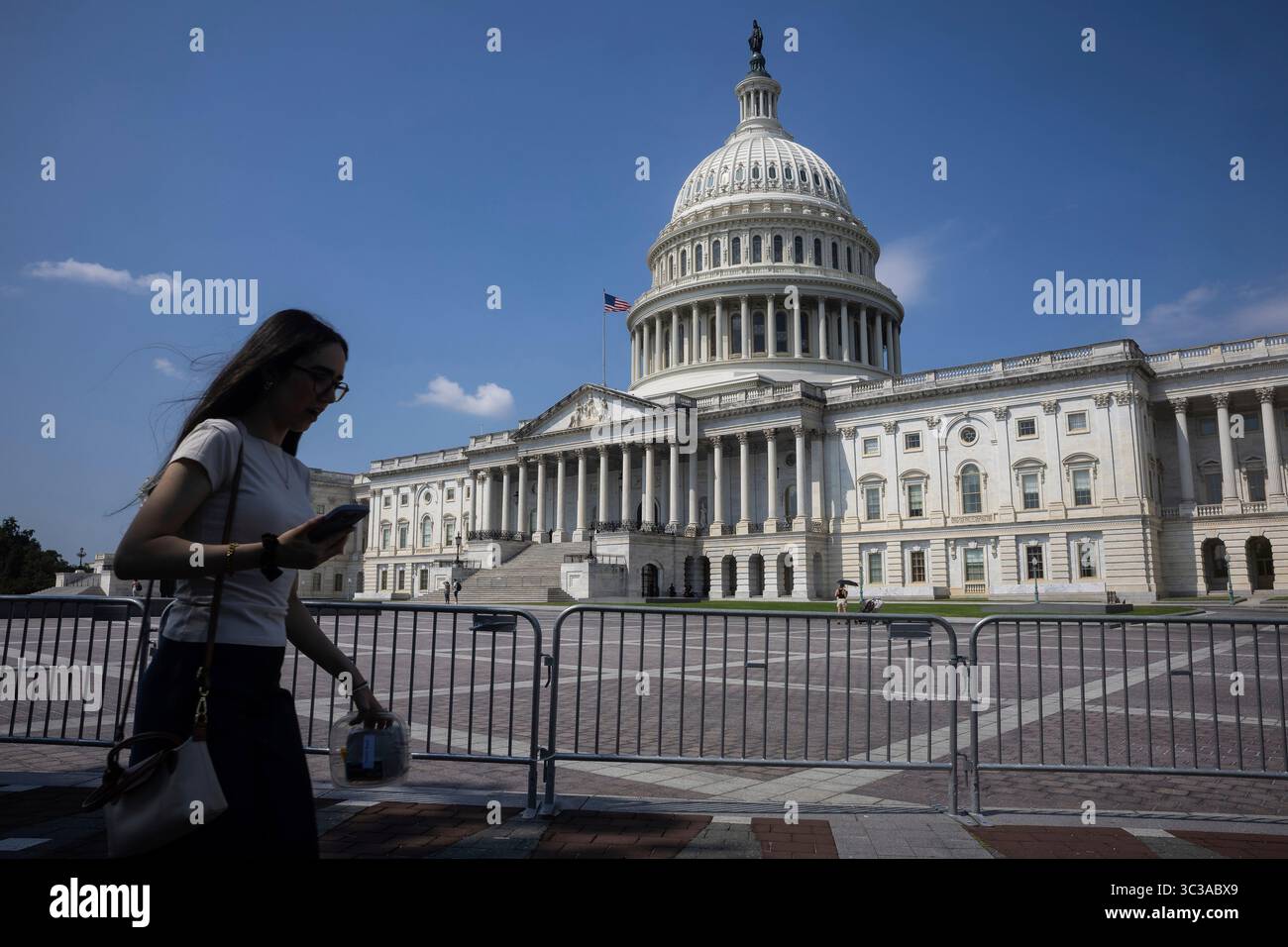 A person walks outside the U.S. Capitol building July 25, 2025 ...