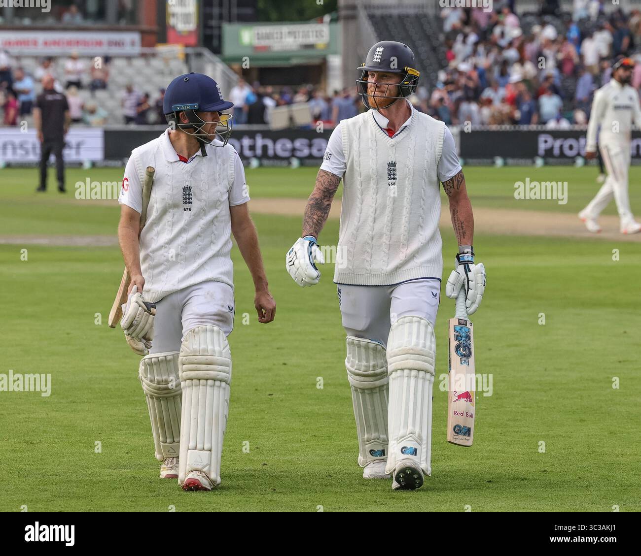 Liam Dawson and England captain Ben Stokes leave the field of play at ...