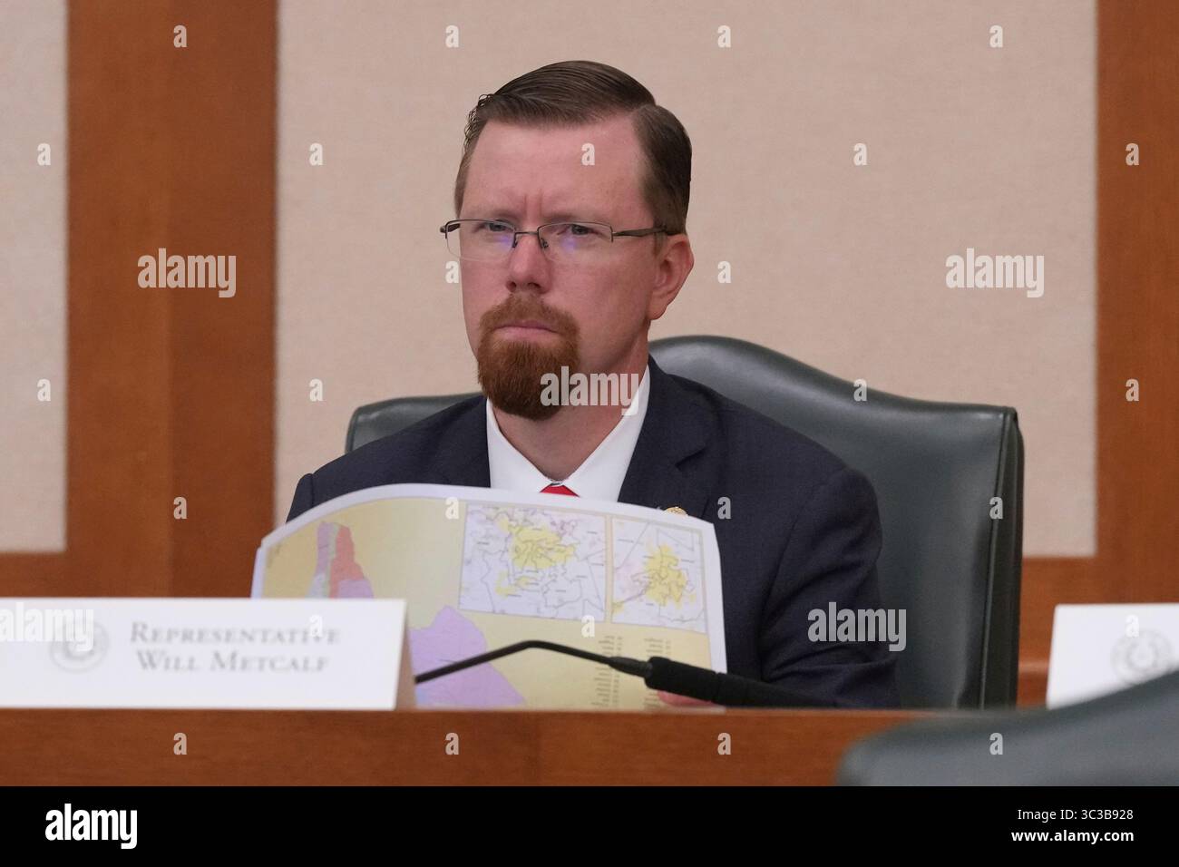 Texas state Rep. Will Metcalf looks at maps during a hearing on ...