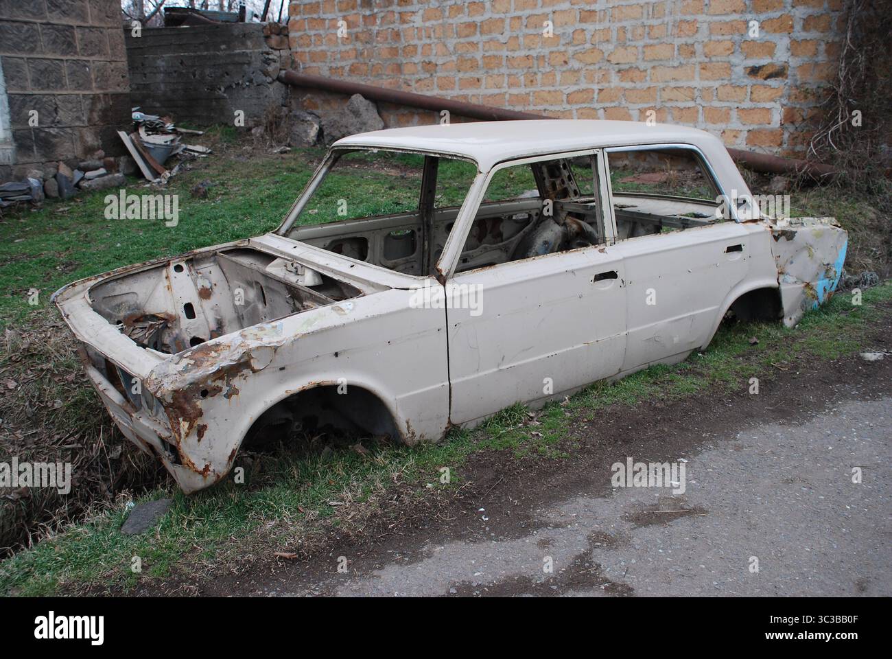 An old soviet Lada car, the bodywork is damaged and rusted, it was left ...