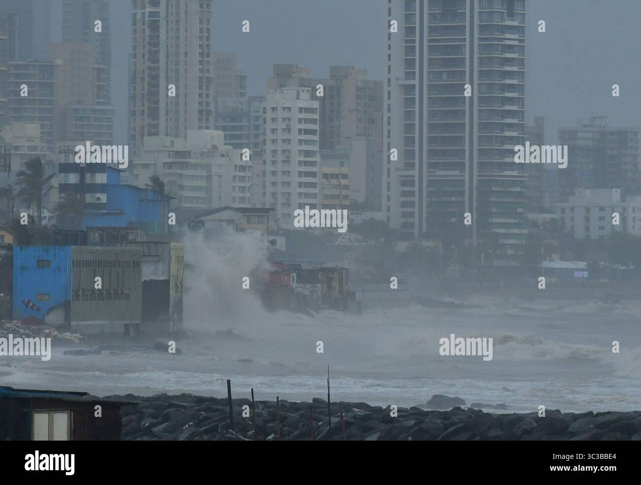 MUMBAI, INDIA - JULY 25: High tide waves splash at the seafront during ...
