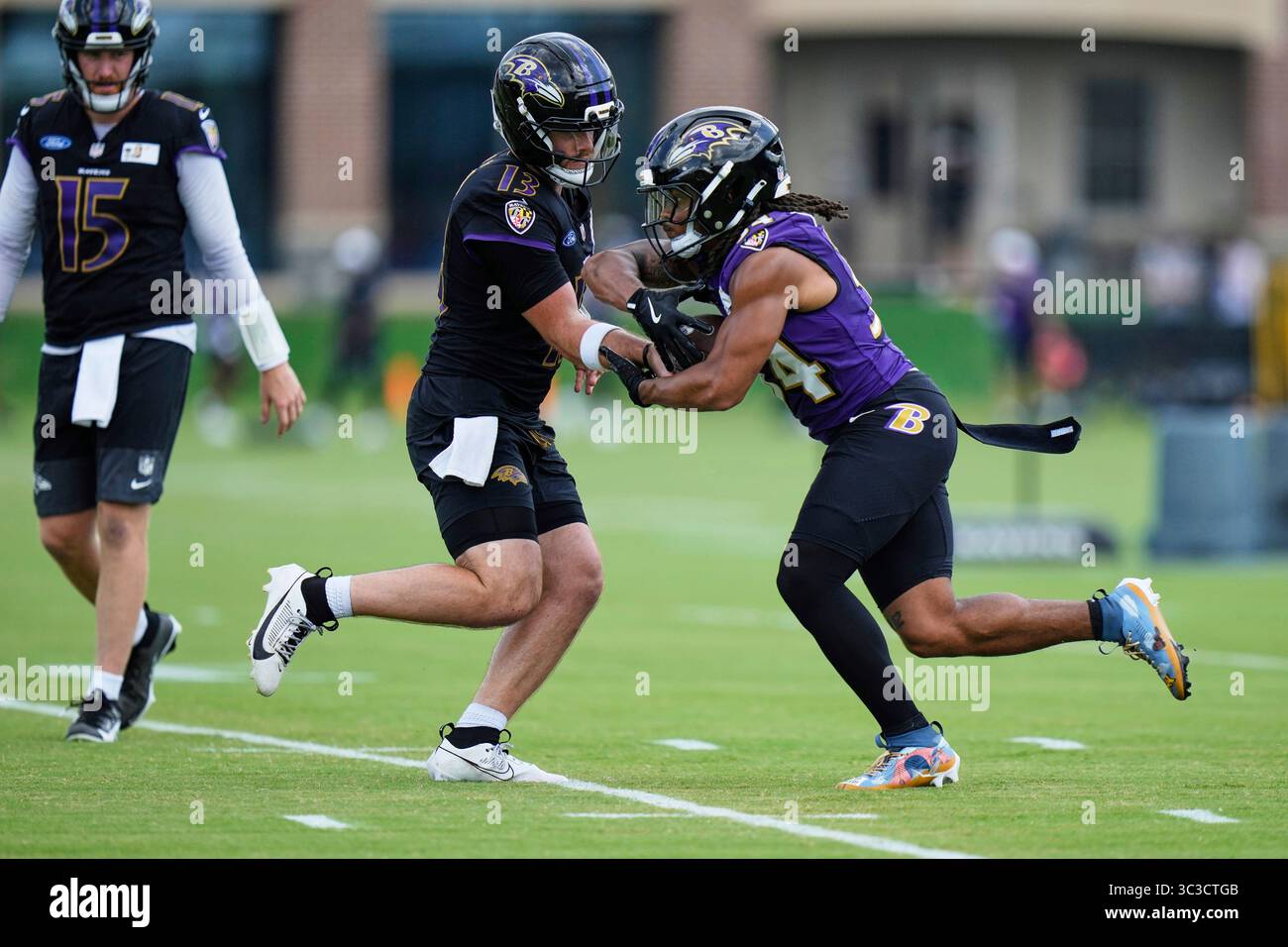 Baltimore Ravens quarterback Devin Leary (13) hands the ball off to ...